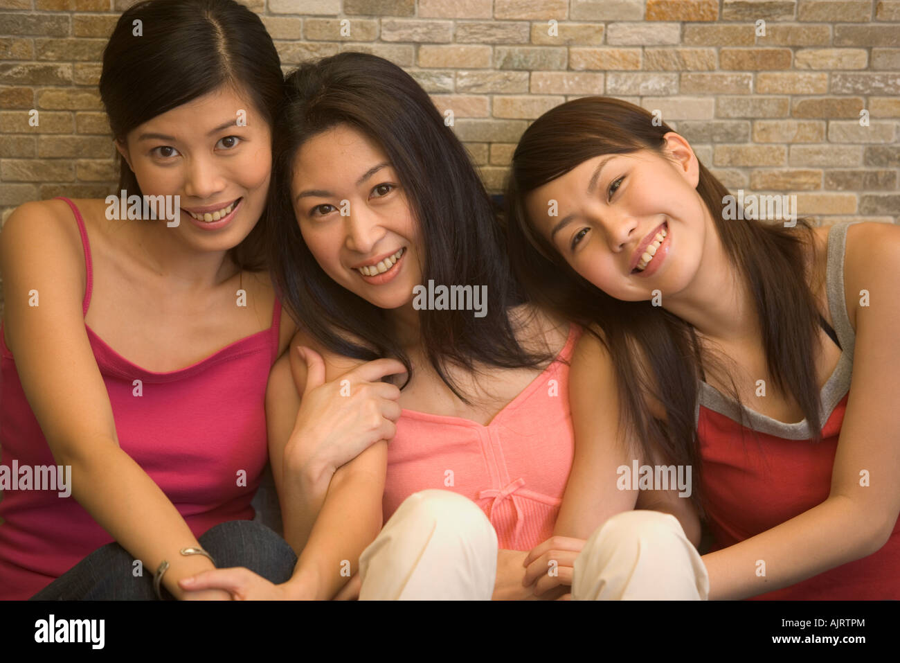 Portrait of three young women sitting together Stock Photo - Alamy