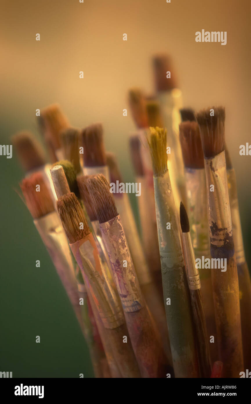 A collection of used paint brushes in an art classroom in an elementary ...