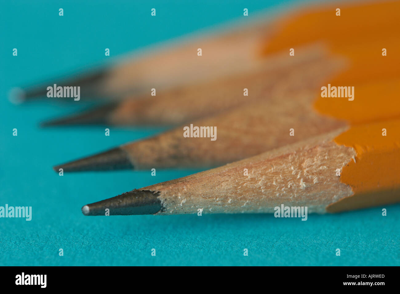 Sharpened pencils on a blue background Stock Photo - Alamy