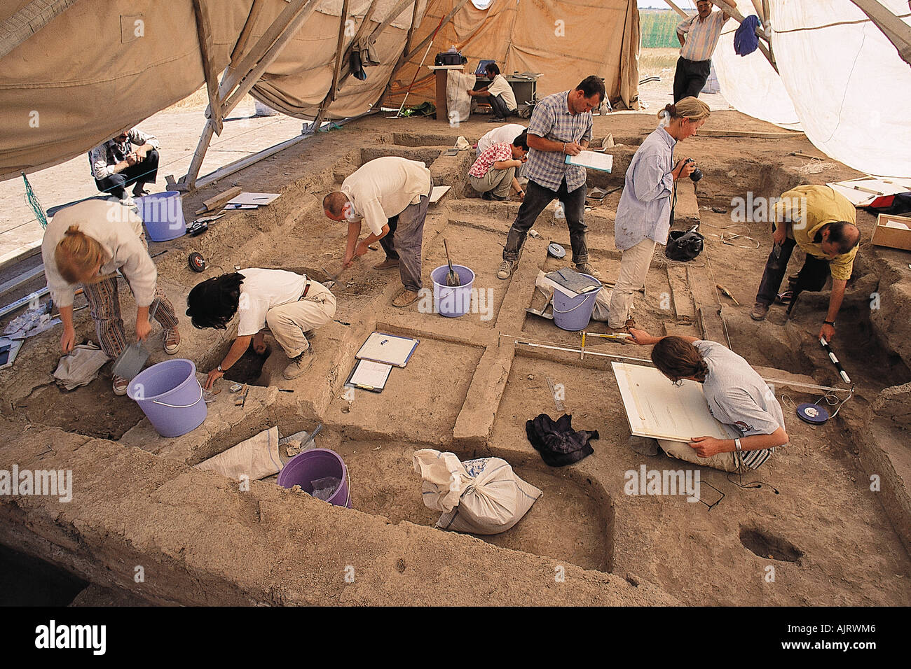 A group of archaeologist digging a Catalhoyuk house composed of a ...