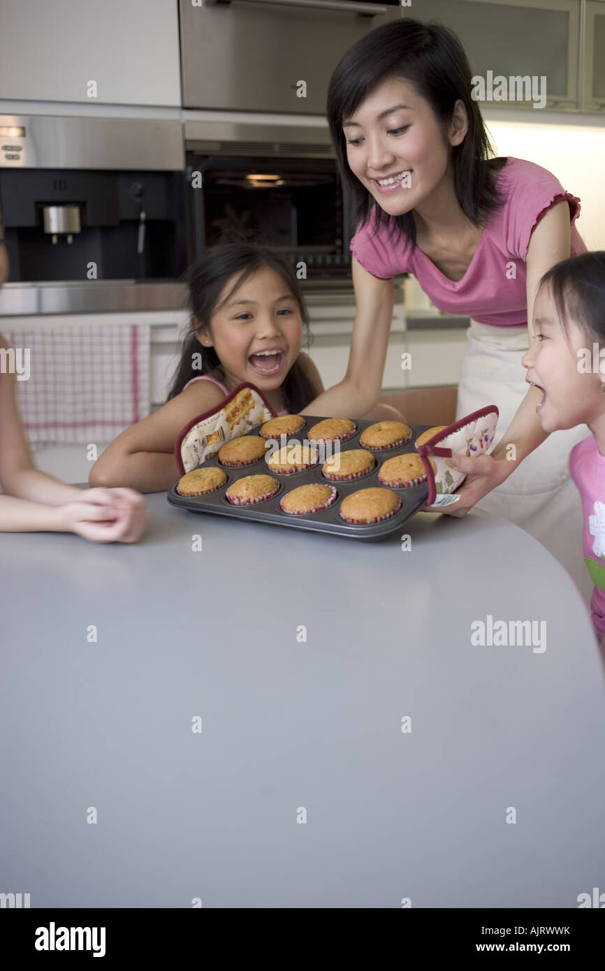 Mother serving cookies to her daughters Stock Photo - Alamy