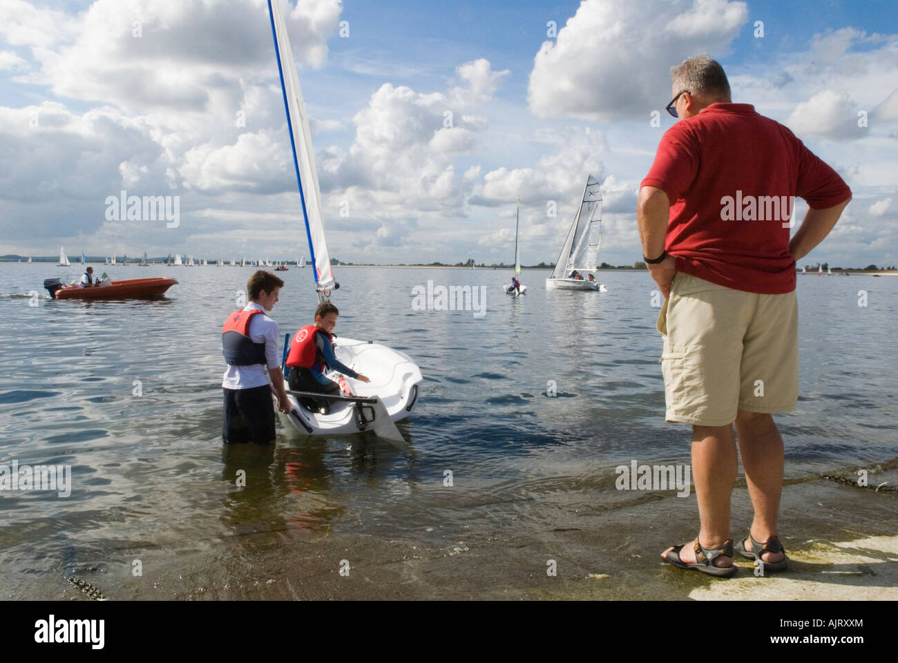 Learning to sail father watching instructor and son. Datchet Water ...