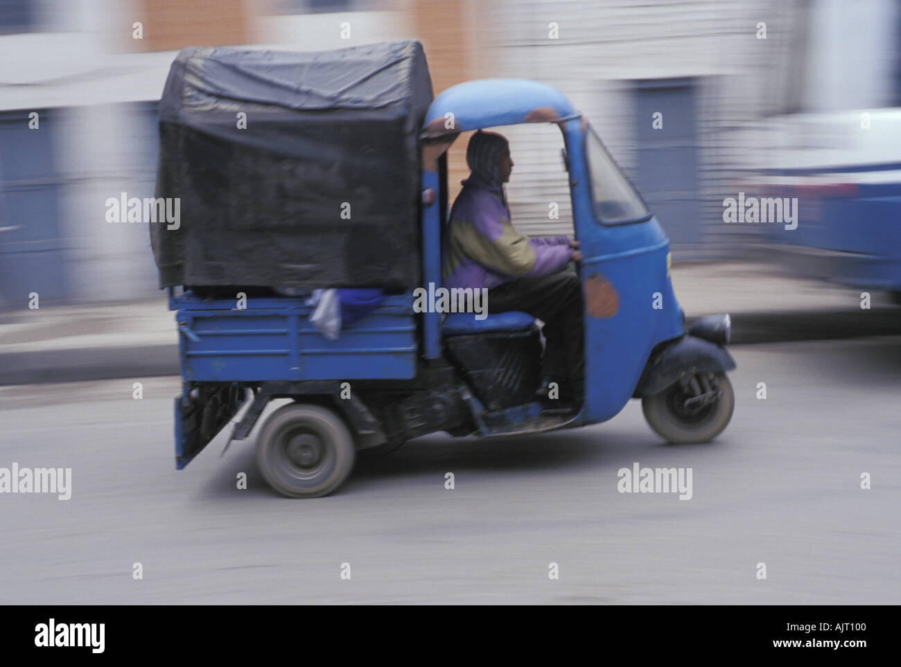 ma driving a three wheeled van Stock Photo - Alamy