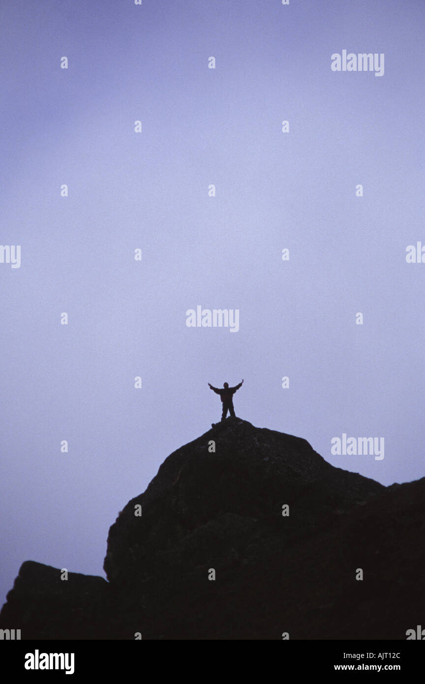 Lone hiker on top of mountain peak Stock Photo - Alamy