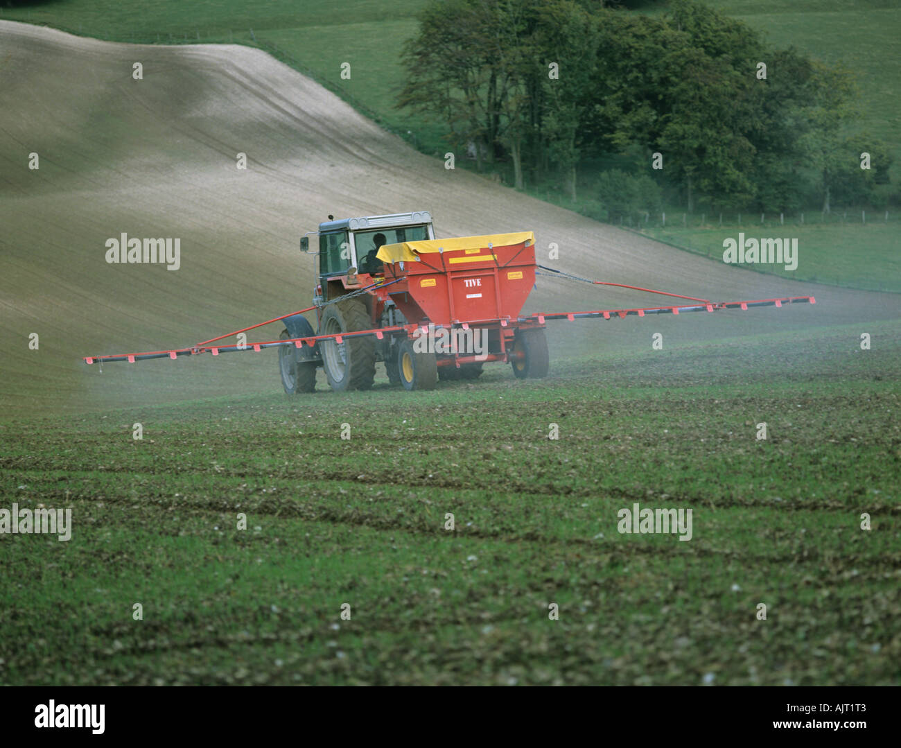 Spreading fertilizer granules on a young barley crop from a Bamlett ...