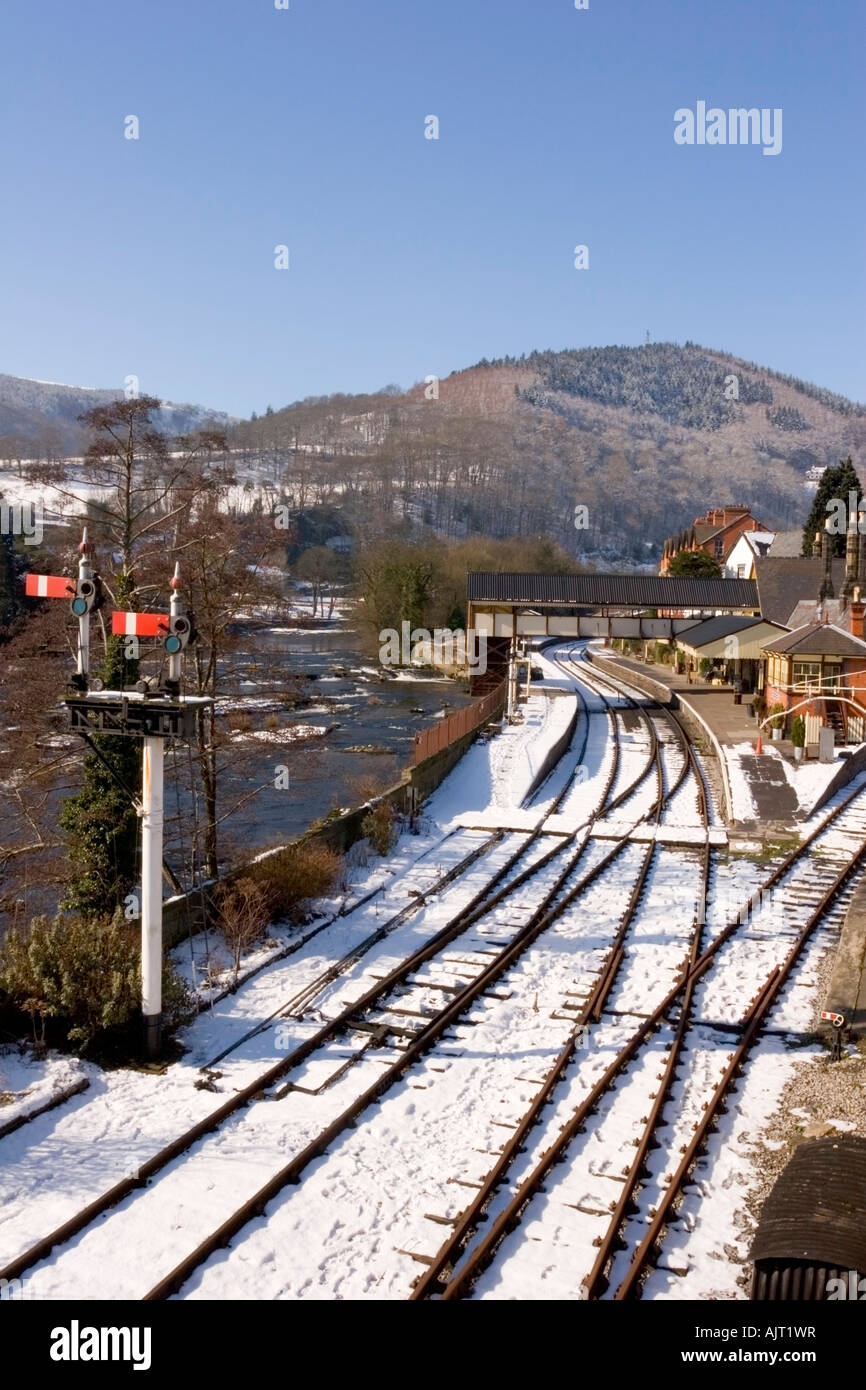 A snowy Llangollen railway station and tracks, along side the River Dee ...