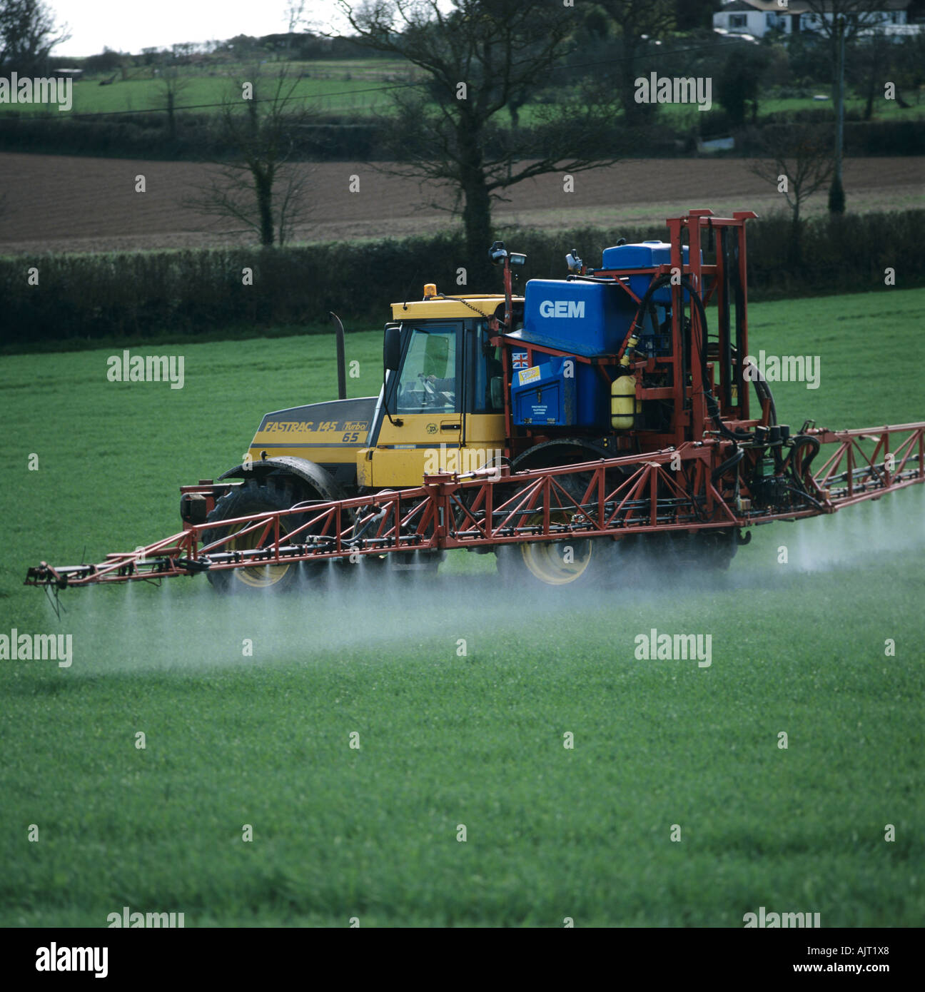 Fastrac tractor with Gem mounted sprayer spraying barley crop in early ...