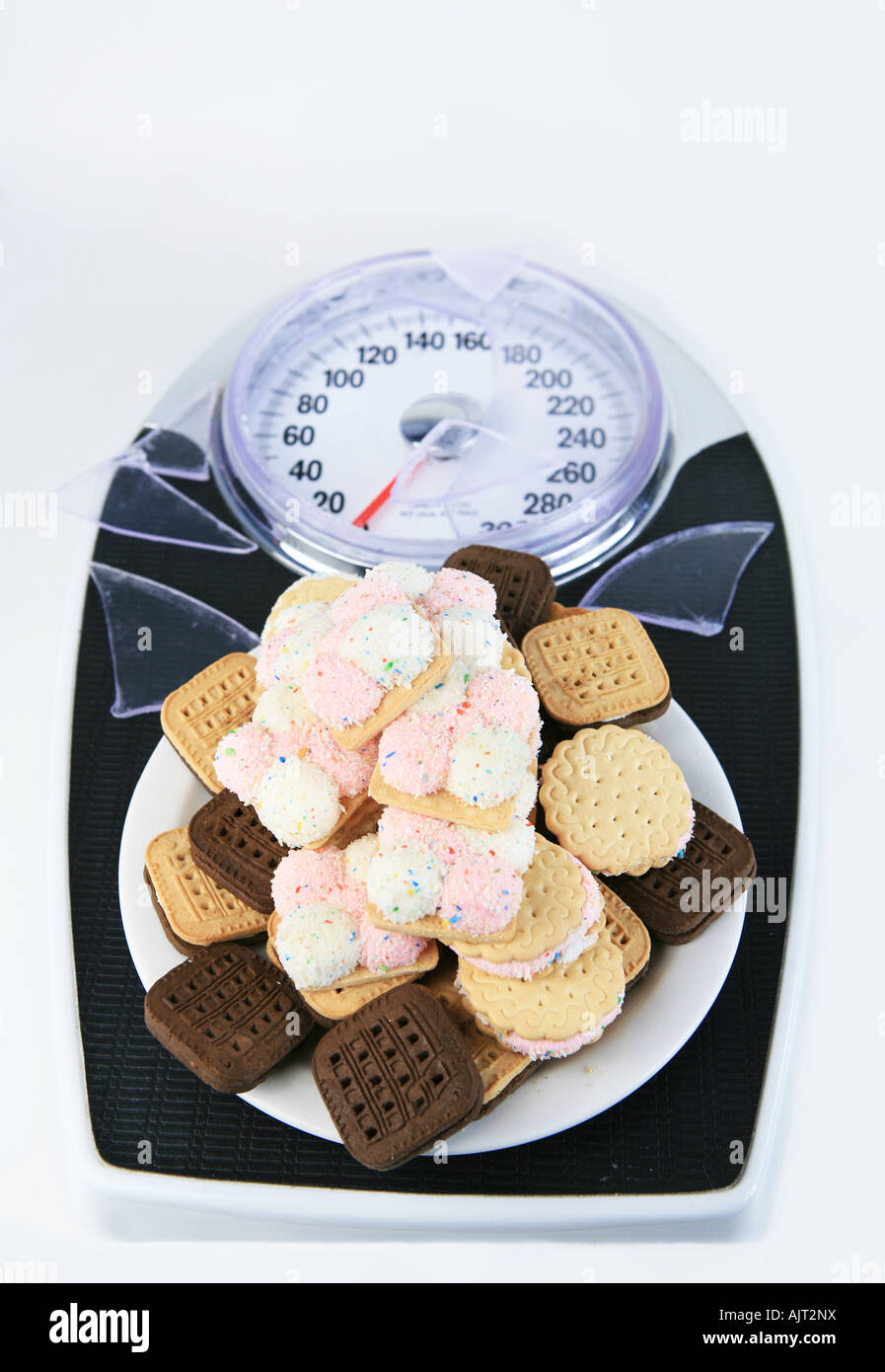 Plate of cookies on broken scale isolated on white background Stock ...