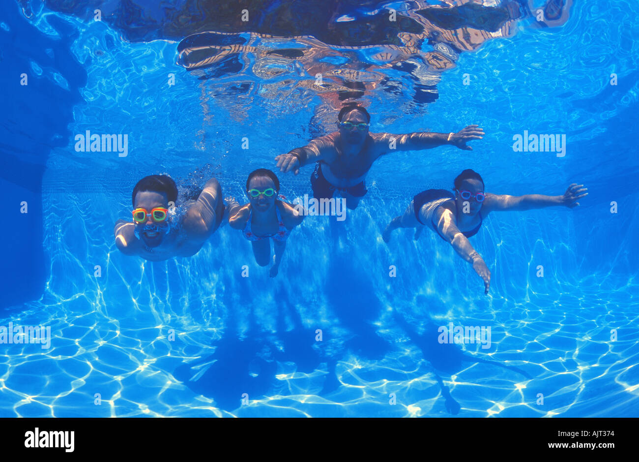 Family in swimming pool Stock Photo - Alamy