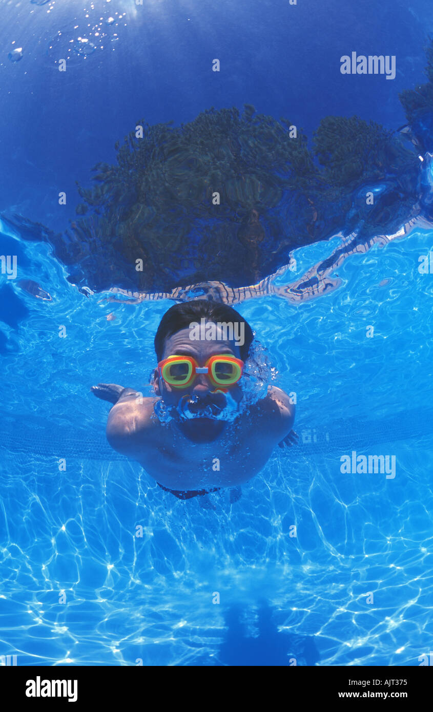 Boy with goggles in swimming pool Stock Photo - Alamy
