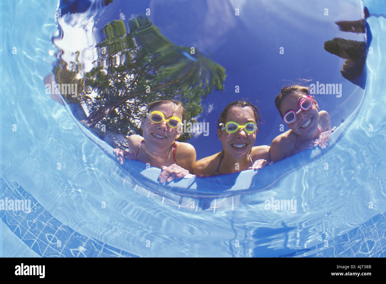 Friends peering into a pool Stock Photo - Alamy