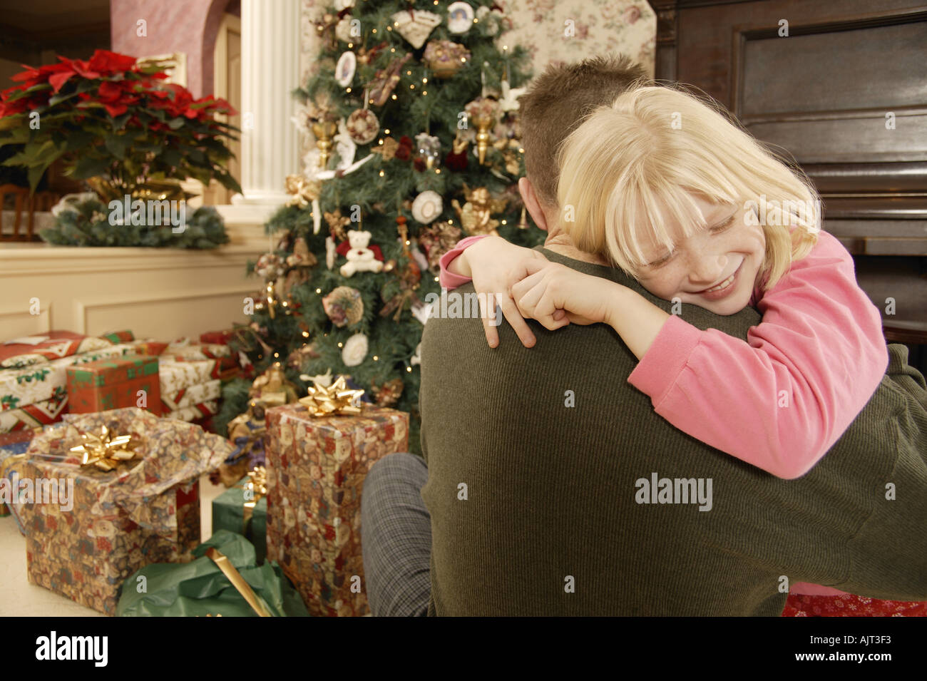 Christmas morning hug Stock Photo - Alamy