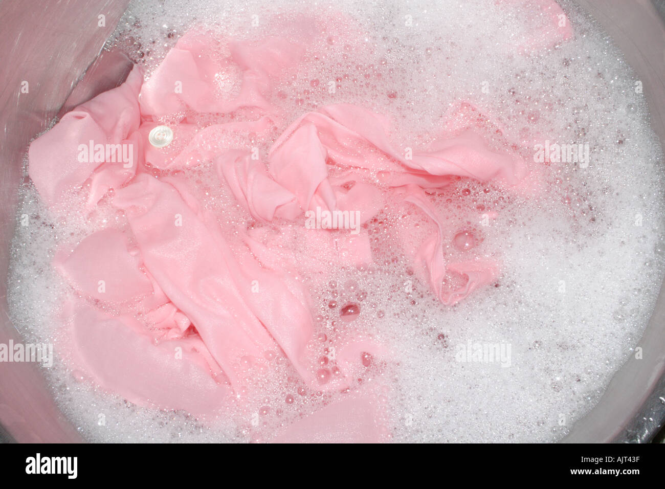 A pink garment being washed Stock Photo - Alamy