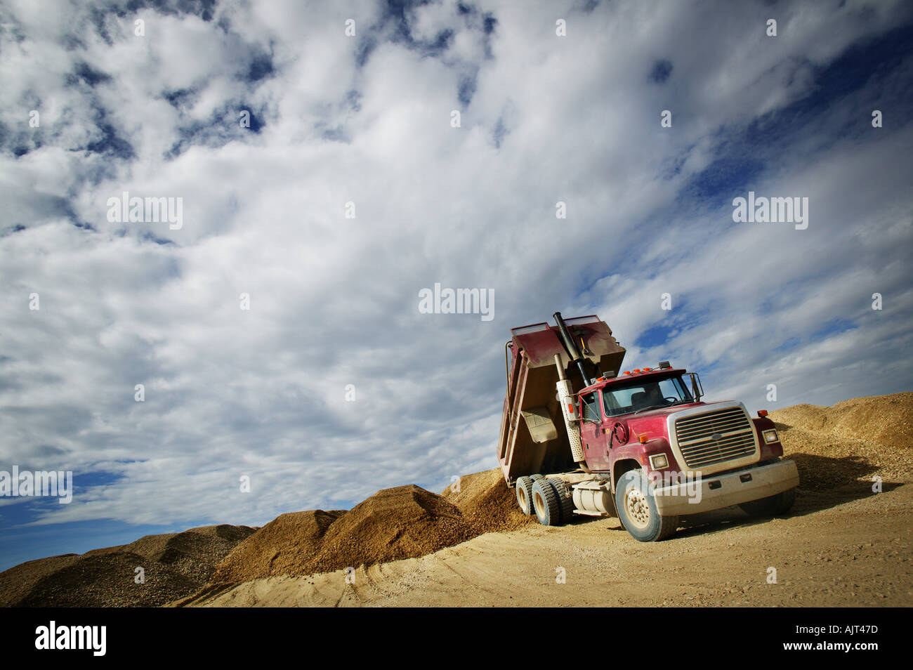 Dump truck unloading Stock Photo - Alamy