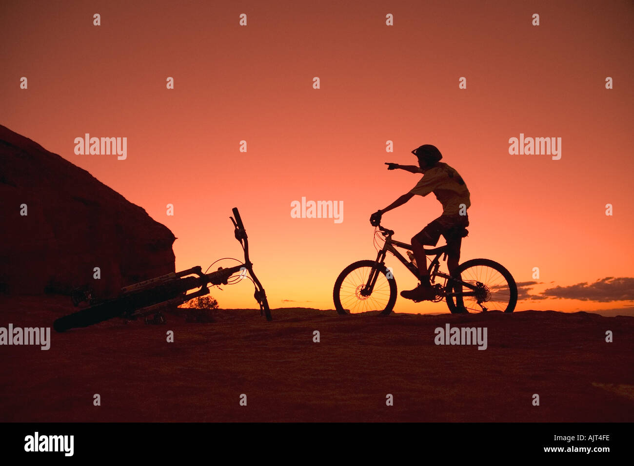 Person on bike pointing Stock Photo - Alamy