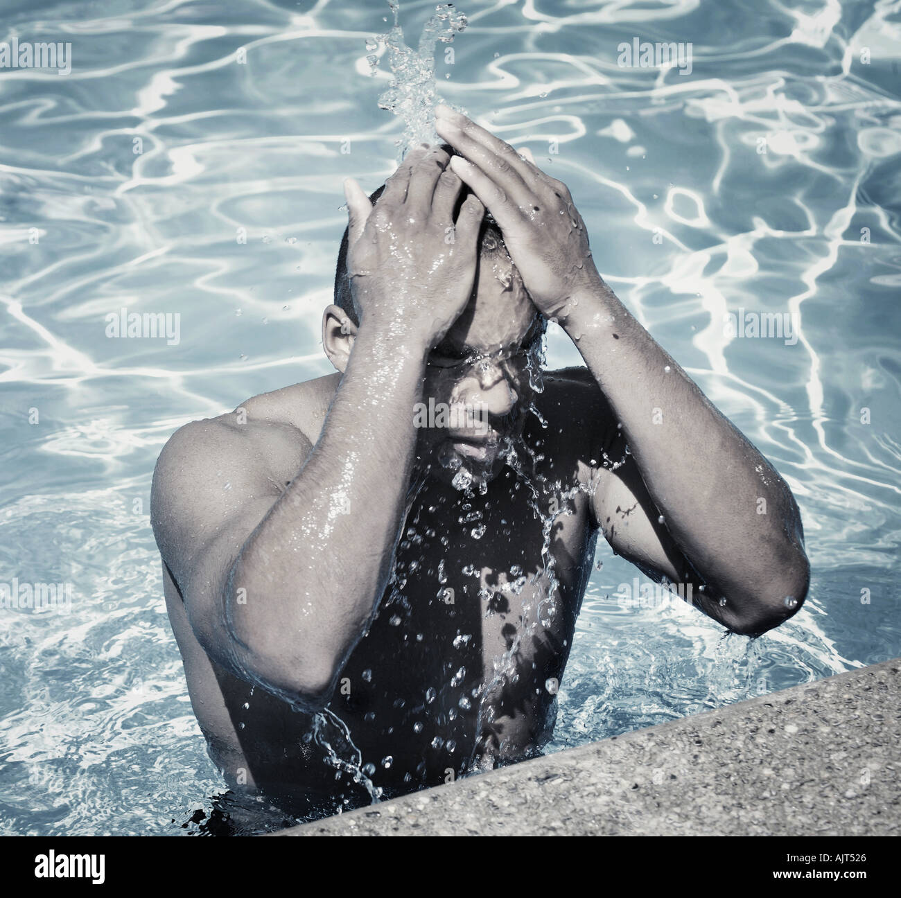 Man splashing in pool Stock Photo - Alamy
