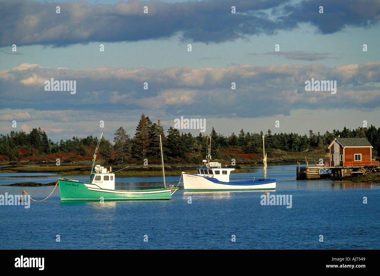 Blue rocks fishing village colorful boats in bay and red fish shack ...