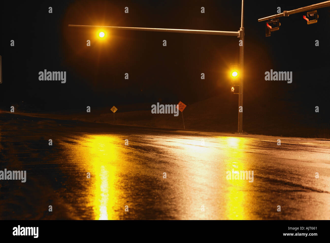 Yellow light at intersection at night Stock Photo - Alamy