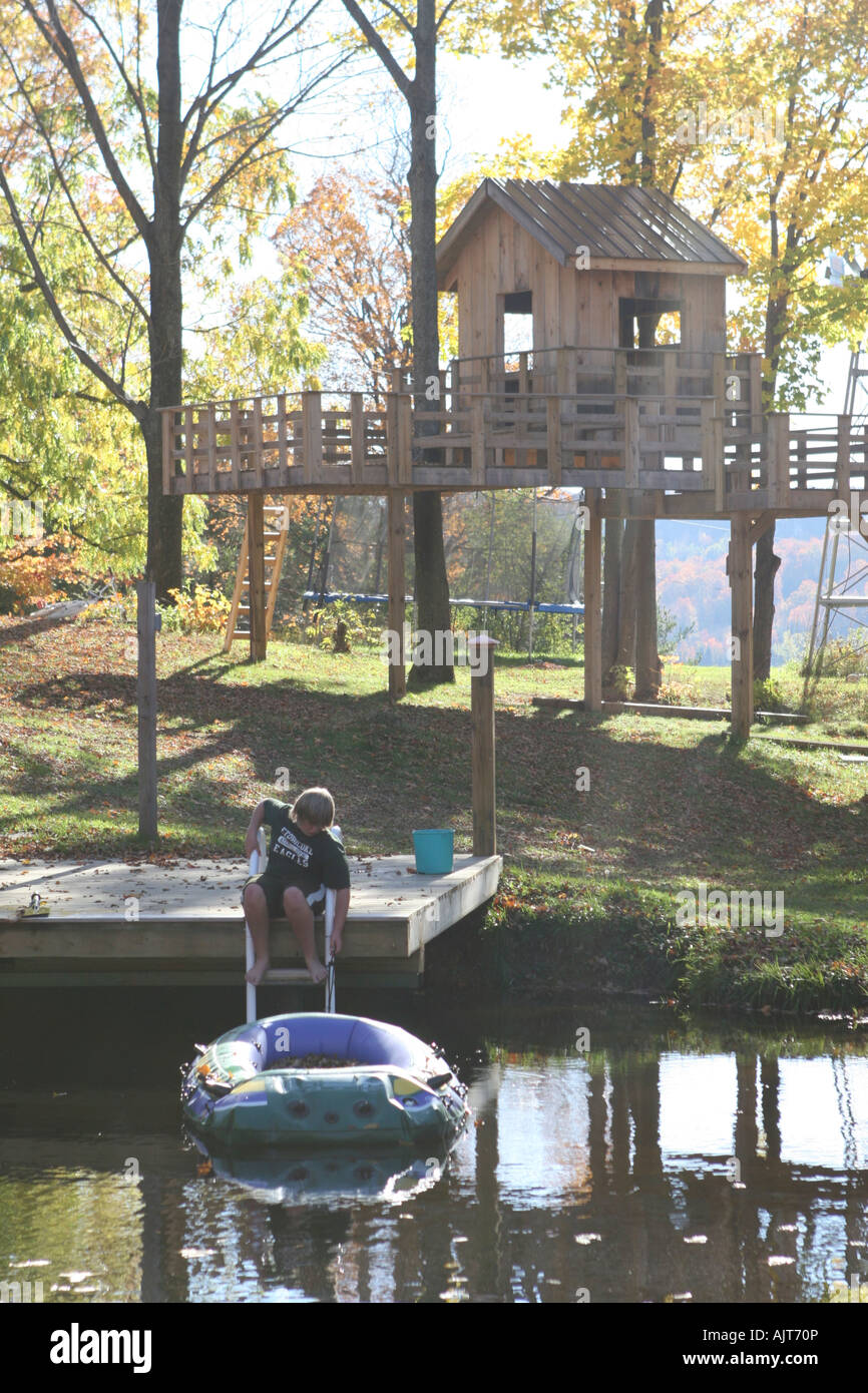 boy sitting on dock Stock Photo - Alamy