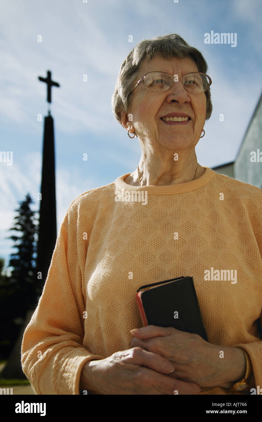 Woman holding bible Stock Photo - Alamy