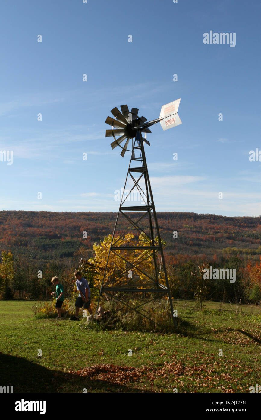 kids playing beside a windmill in autumn Stock Photo - Alamy