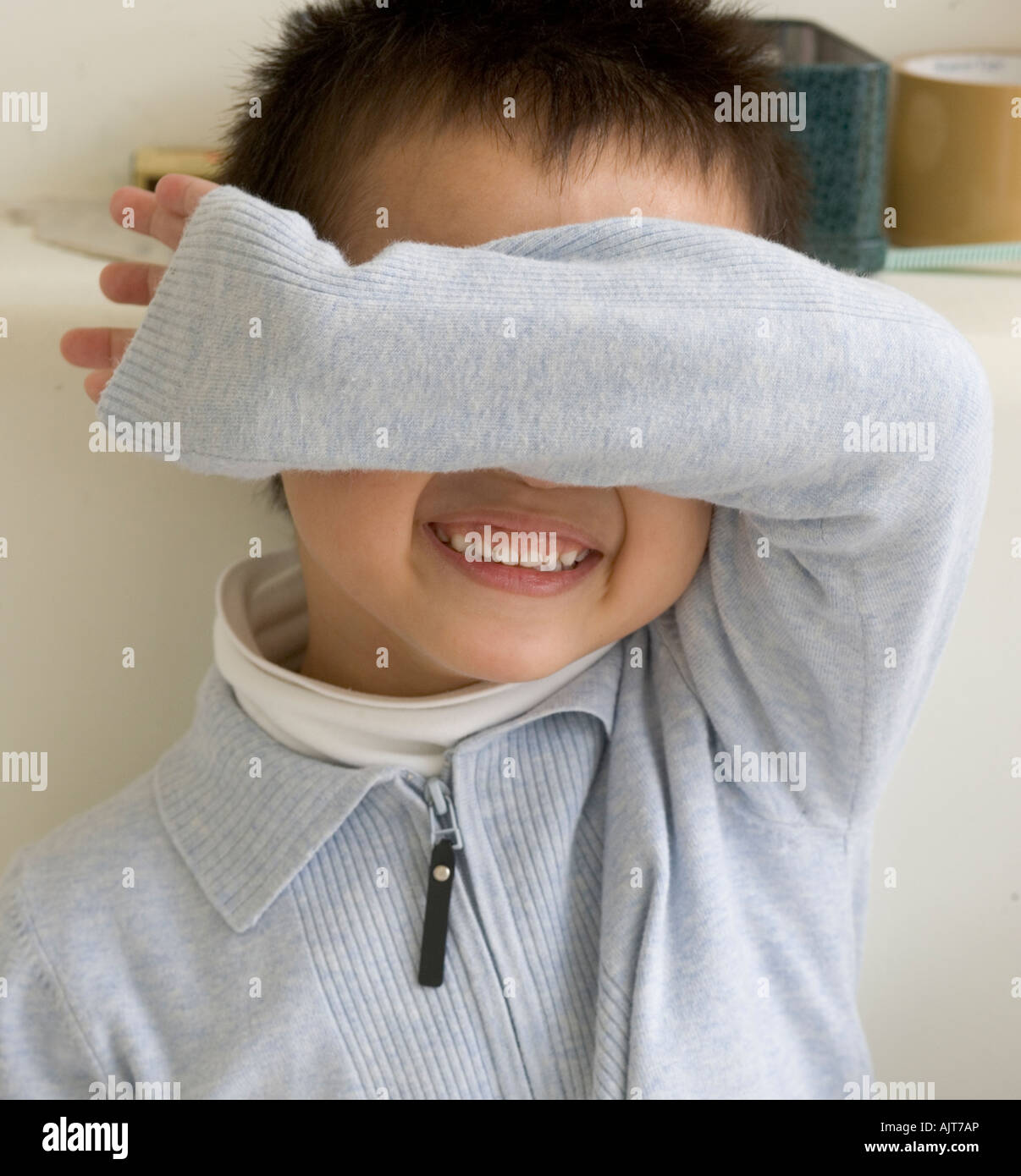 Portrait of a boy covering eyes with his arm Stock Photo - Alamy