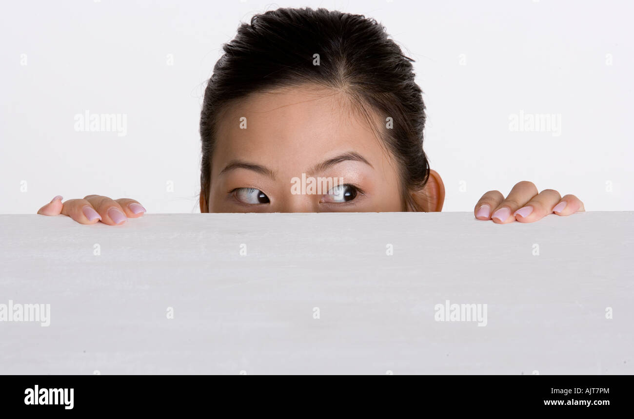 Woman peeking sideways hi-res stock photography and images - Alamy
