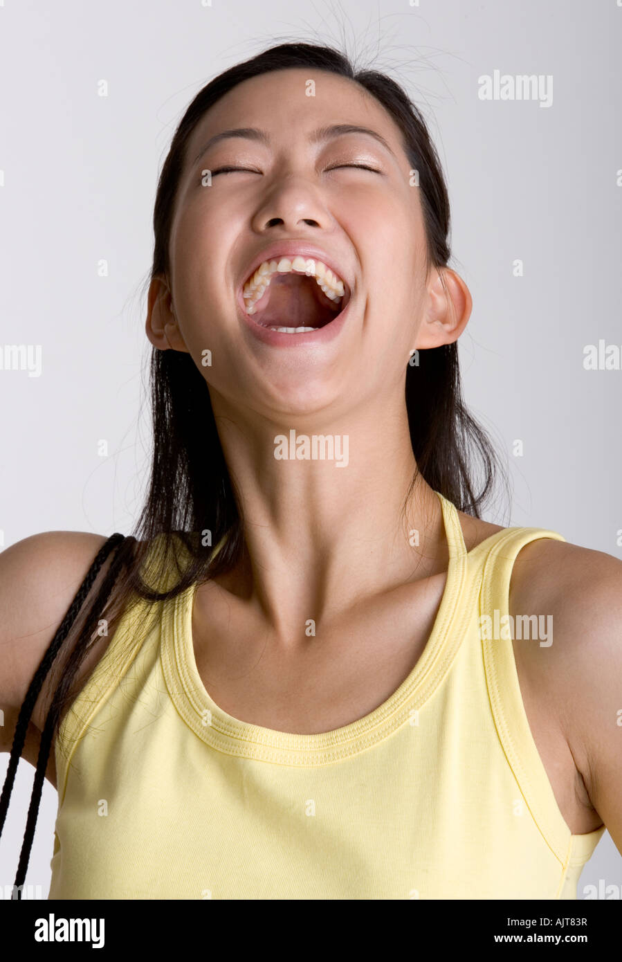 Close-up of a young woman laughing Stock Photo - Alamy