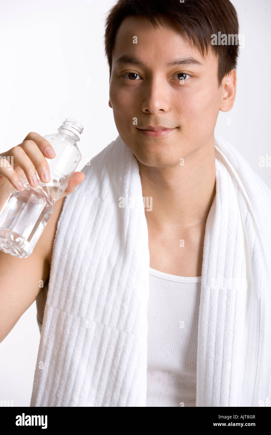 Portrait of a young man holding a water bottle Stock Photo - Alamy