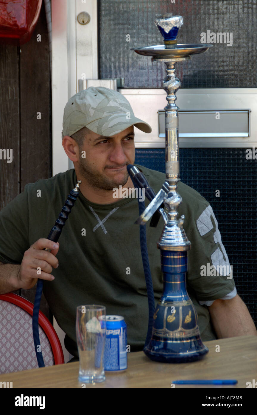 An arabic person dressed in western clothes smoking hookah Stock Photo ...