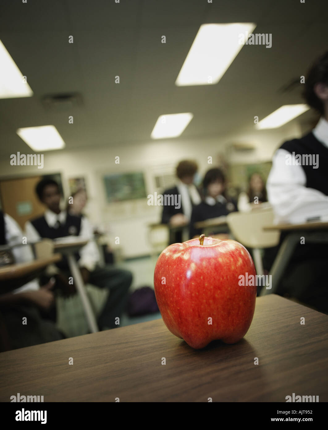 Red apple on classroom desk Stock Photo - Alamy