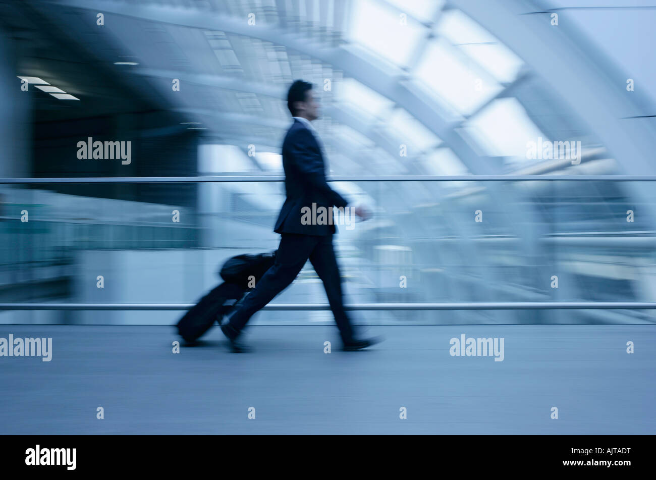 Side profile of a businessman pulling his luggage Stock Photo - Alamy