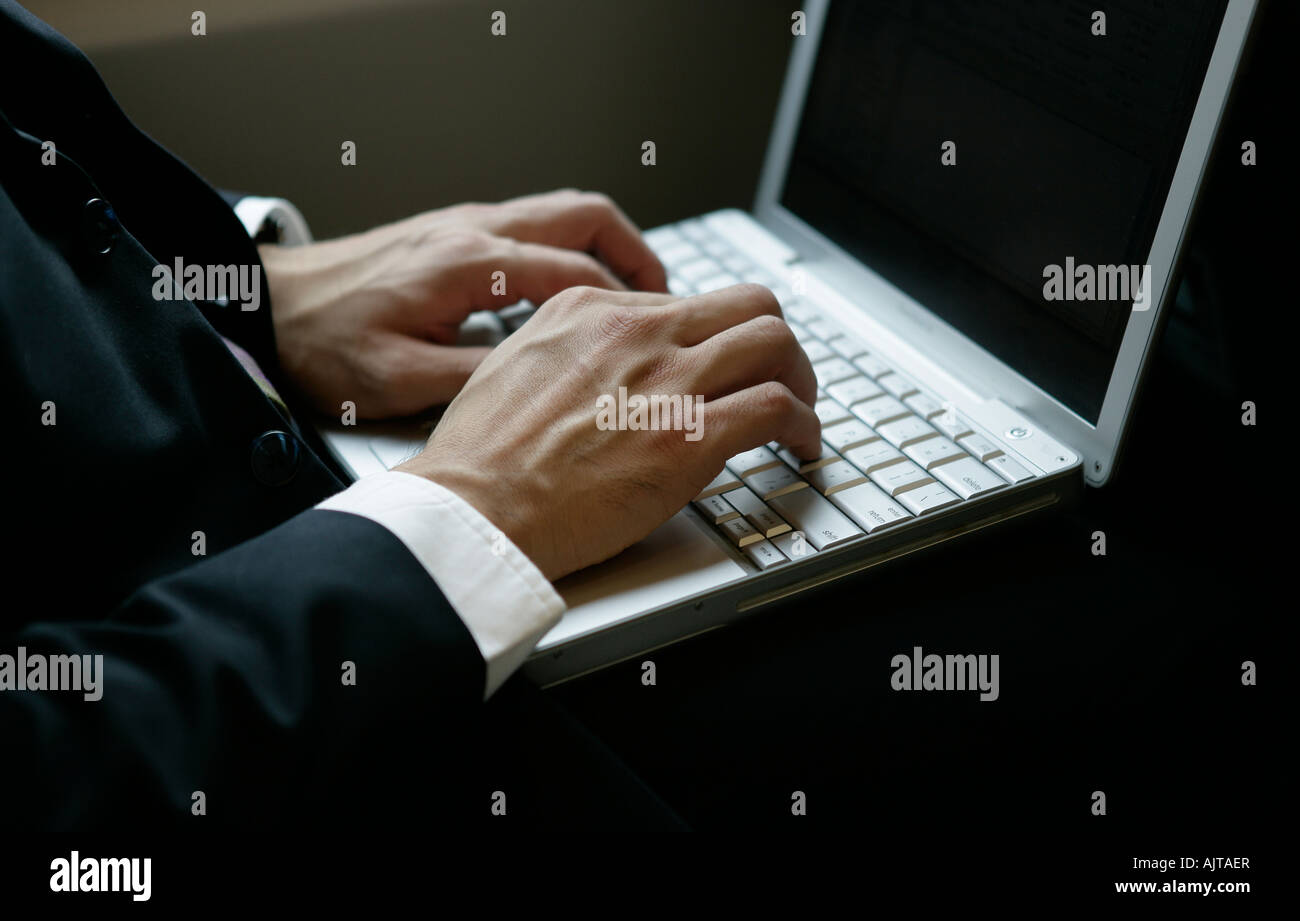 Mid section view of a businessman using a laptop Stock Photo - Alamy