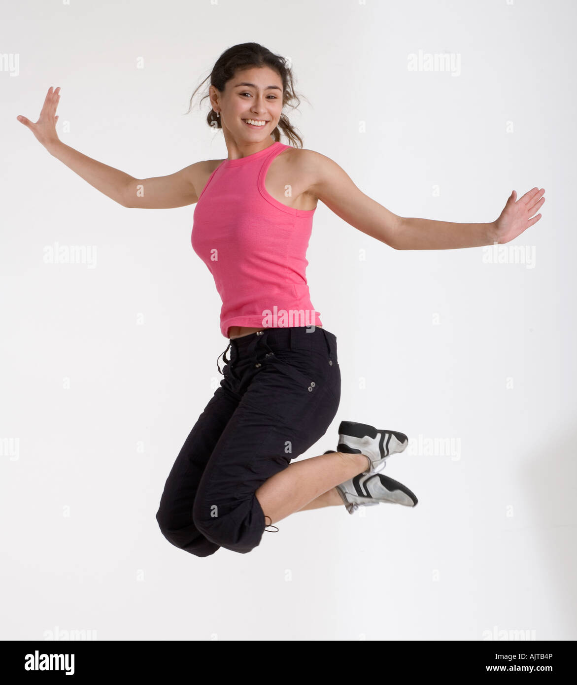 Portrait of a young woman jumping Stock Photo - Alamy