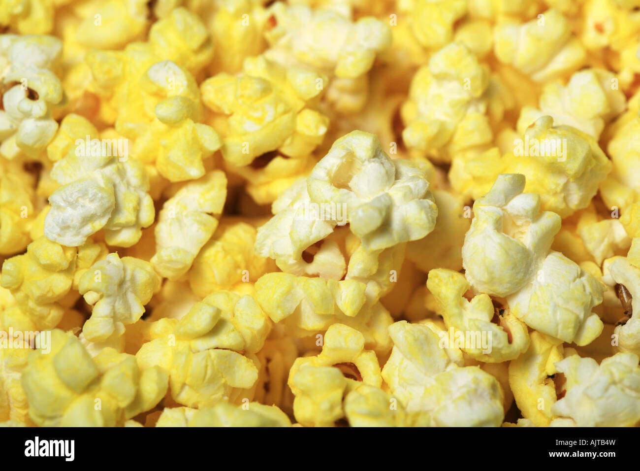 Yellow buttered popcorn background Stock Photo - Alamy