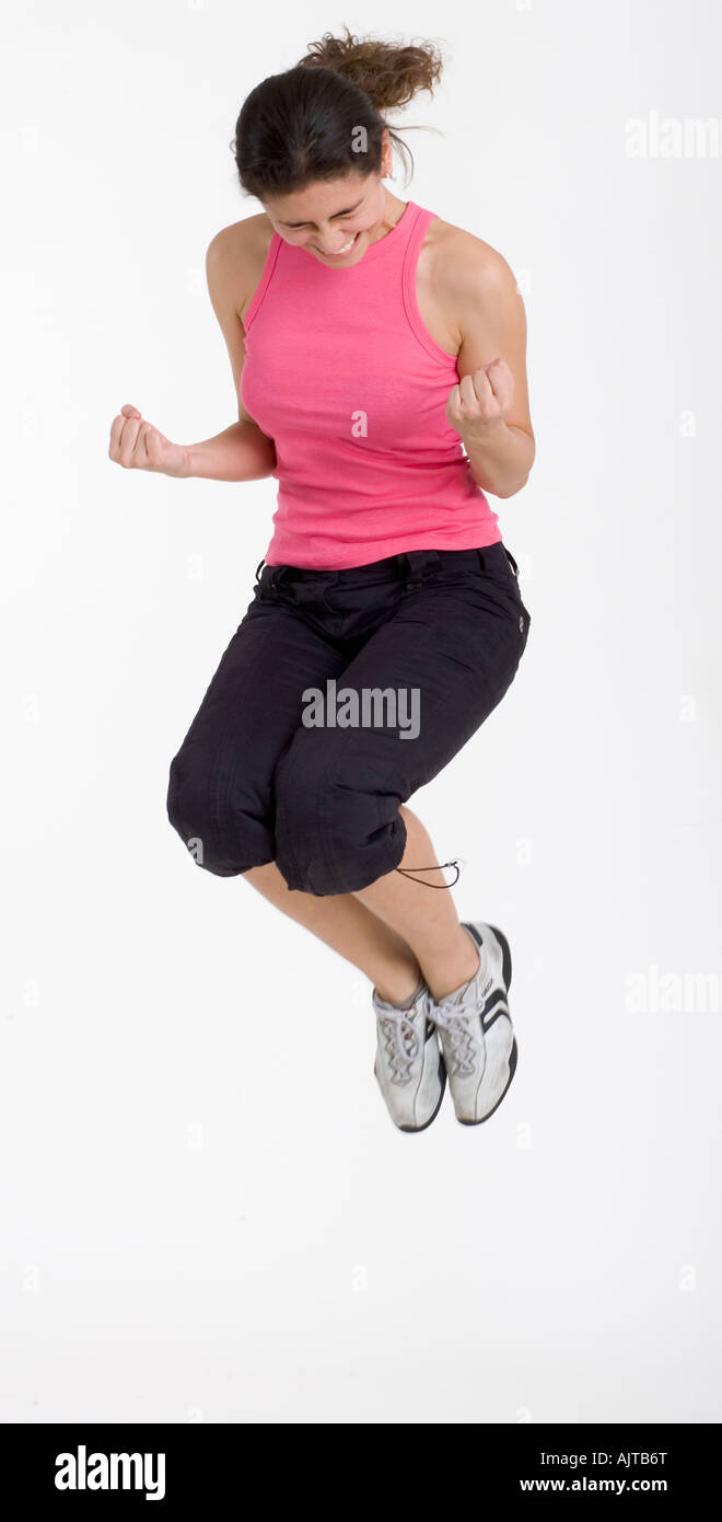 Young woman jumping with joy Stock Photo - Alamy
