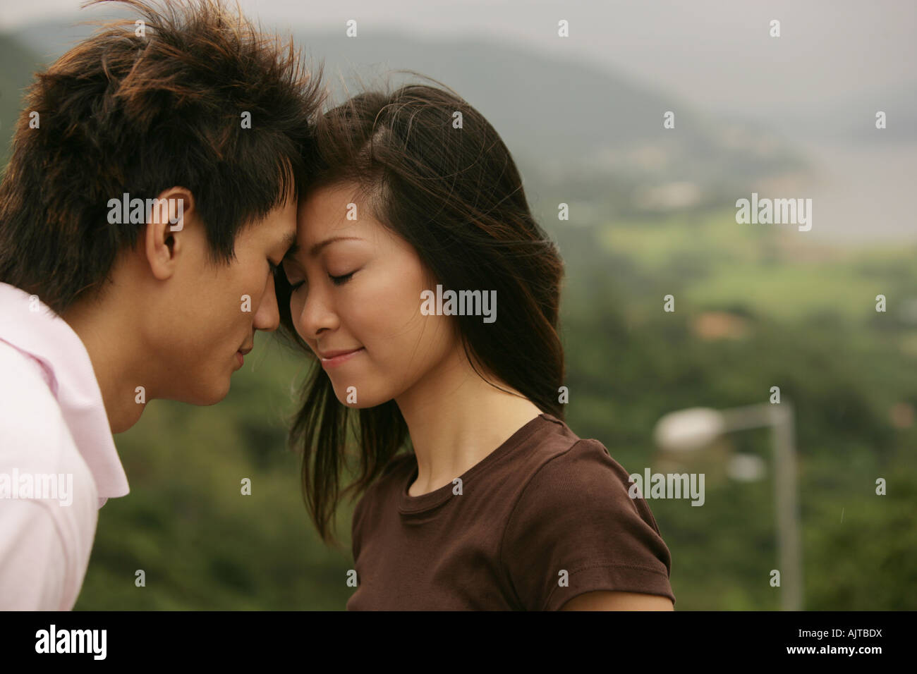 Young couple face to face Stock Photo - Alamy