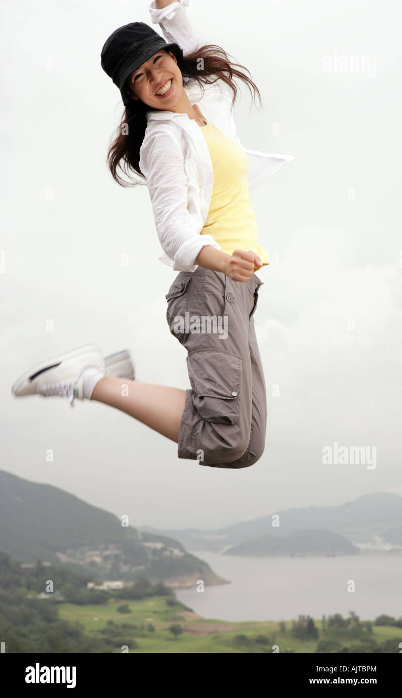 Side profile of a young woman jumping Stock Photo - Alamy