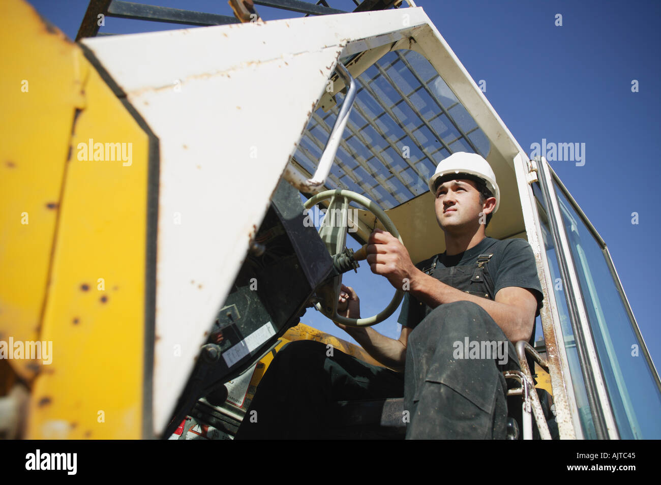 Construction worker using equipment Stock Photo - Alamy