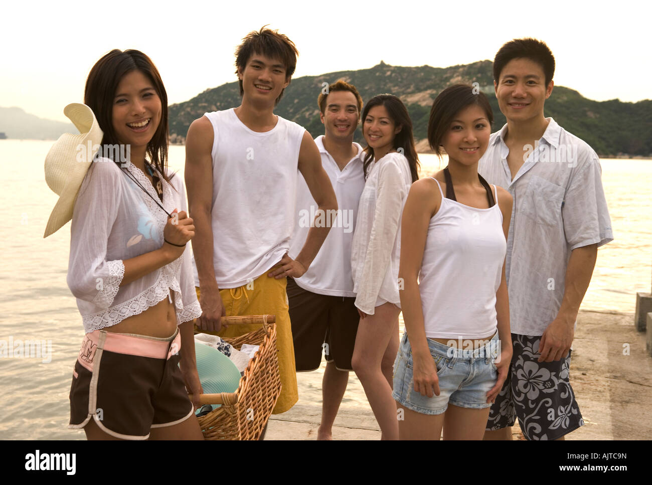 Portrait of three young couples standing on a pier Stock Photo - Alamy
