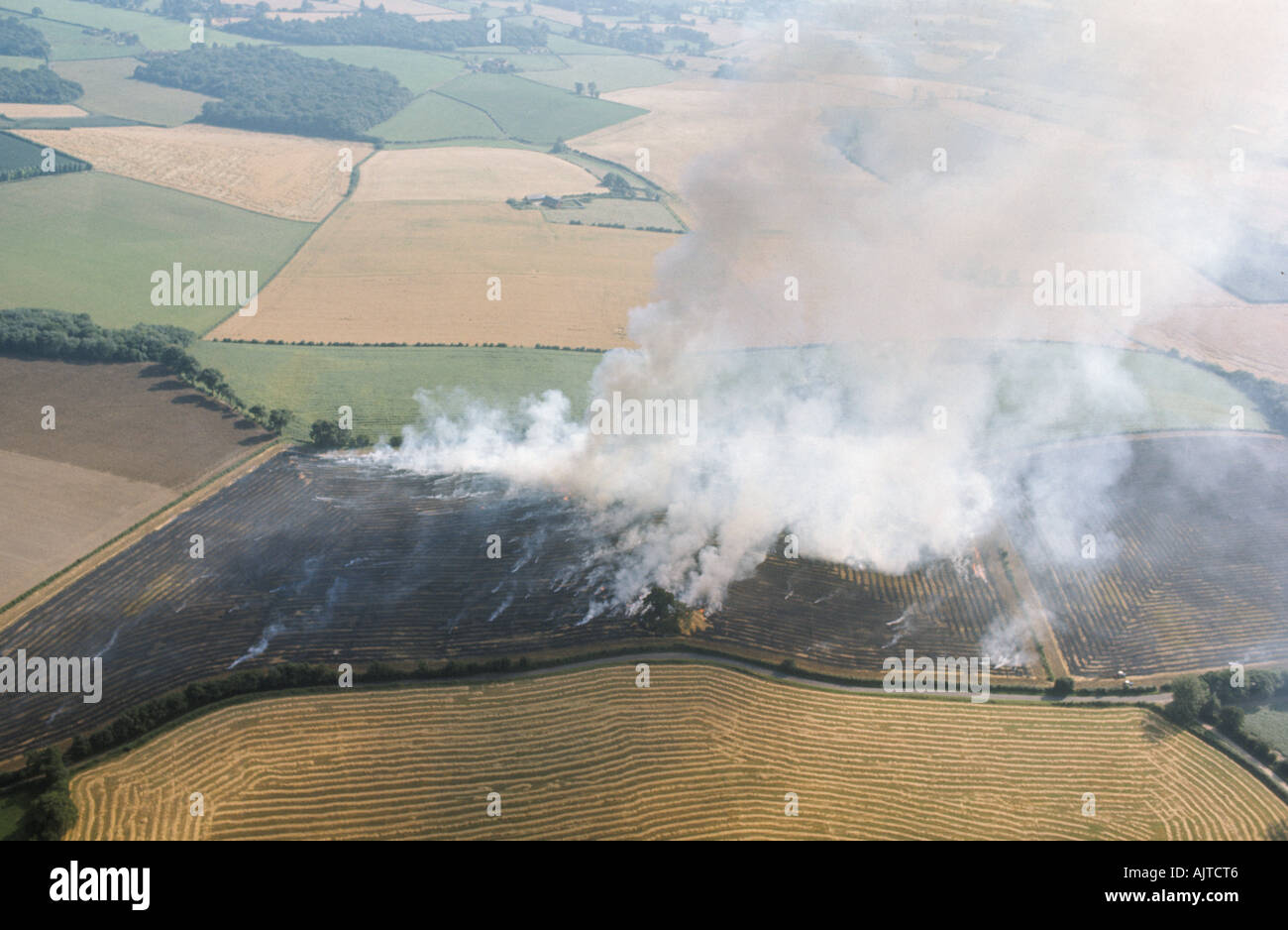Aerial view of field of straw stubble burning after cereal harvest ...