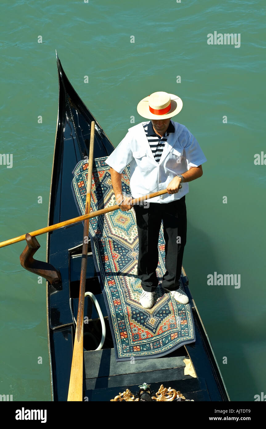 Gondolier in a gondola wearing a straw hat Stock Photo - Alamy