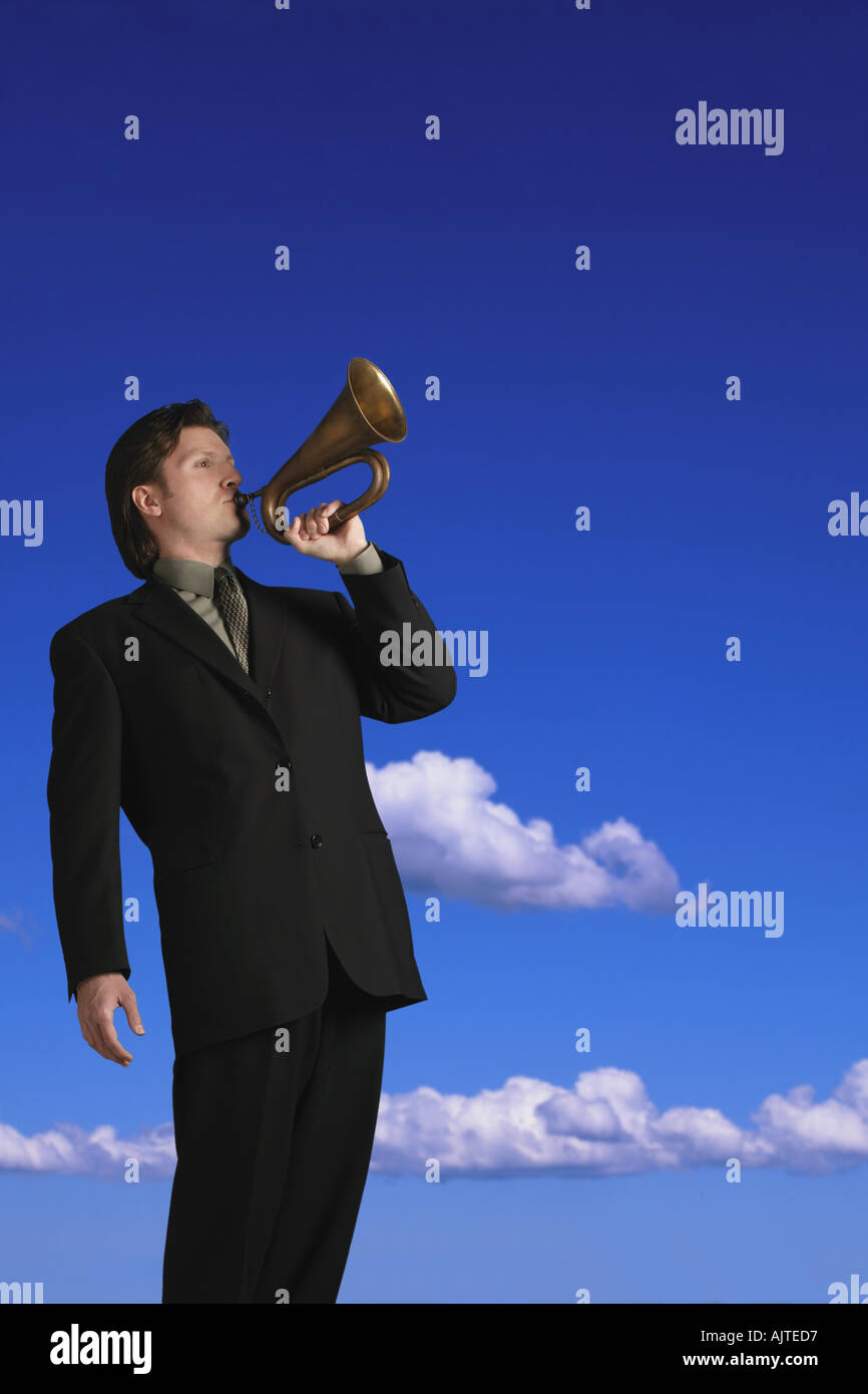 Man in suit blowing a bugle Stock Photo - Alamy