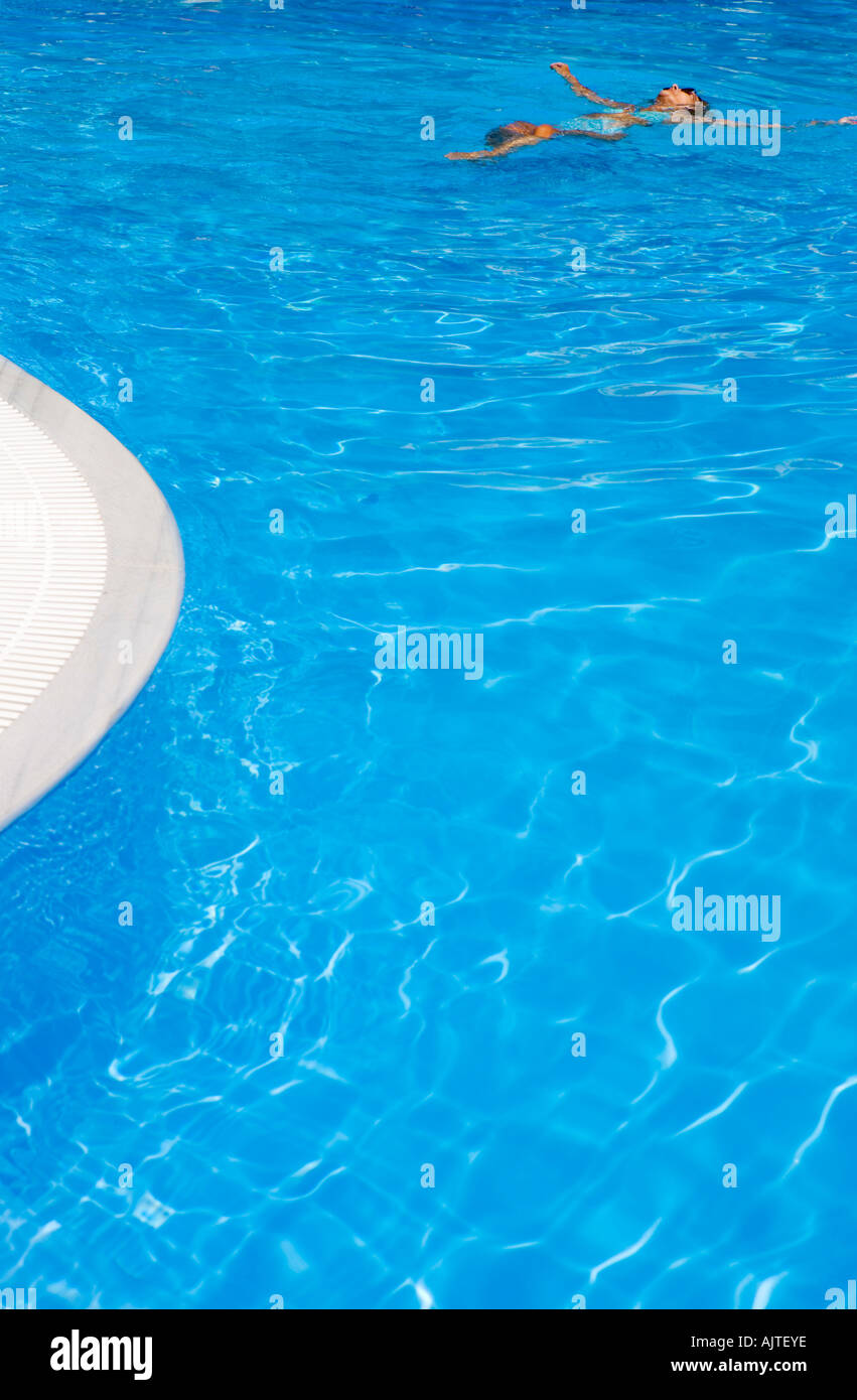 WOMAN FLOATING IN A SWIMMING POOL Stock Photo - Alamy