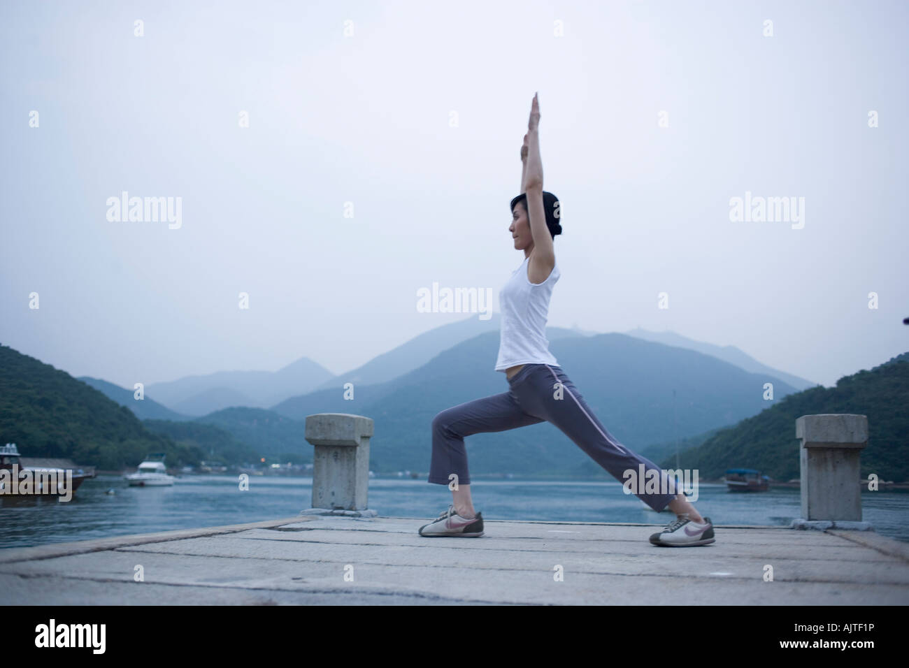 Side profile of a young woman stretching Stock Photo - Alamy
