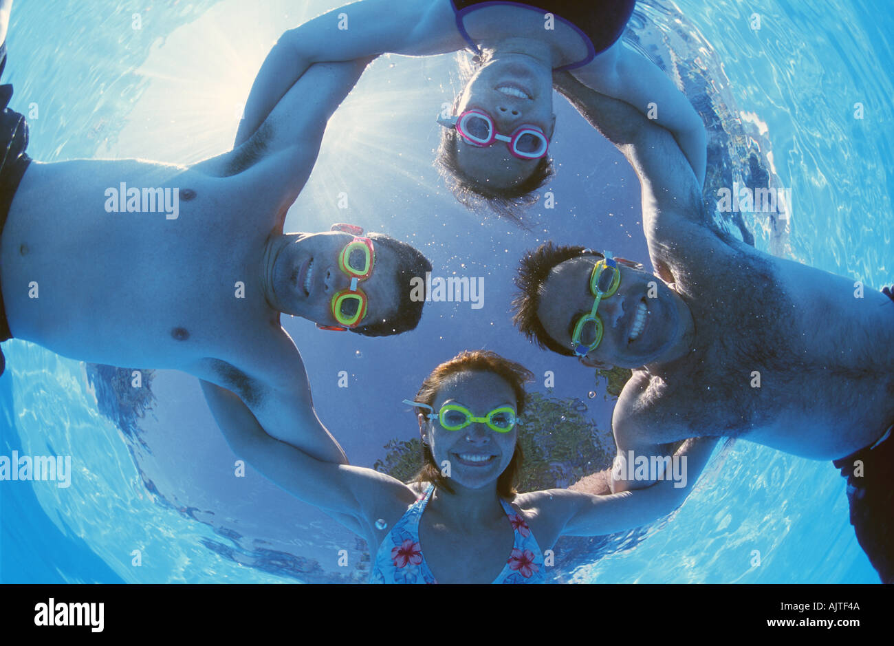 Four adults in swimming pool Stock Photo - Alamy