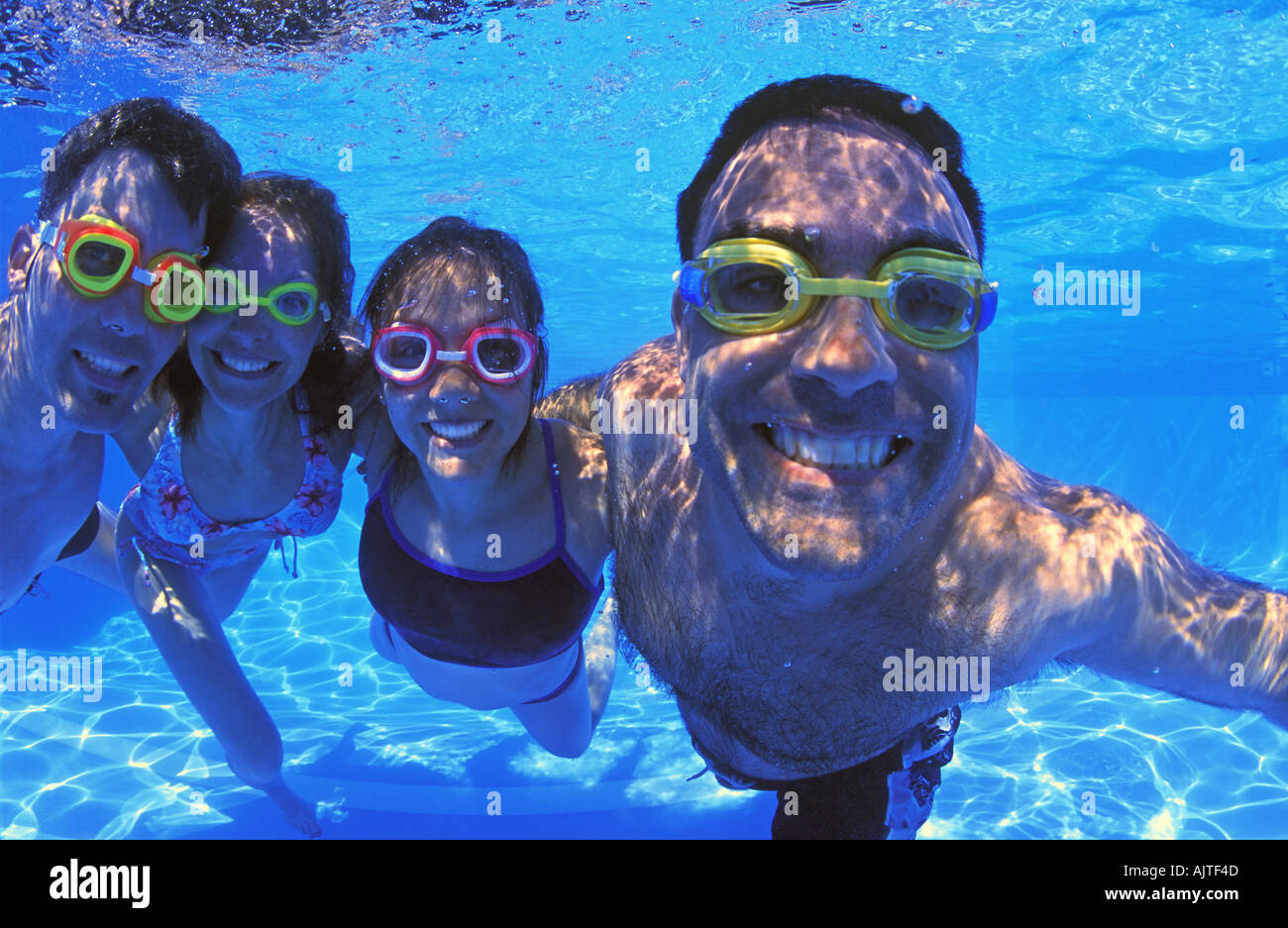 Family group in swimming pool Stock Photo - Alamy