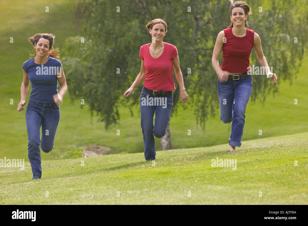 Three teen girls running Stock Photo - Alamy