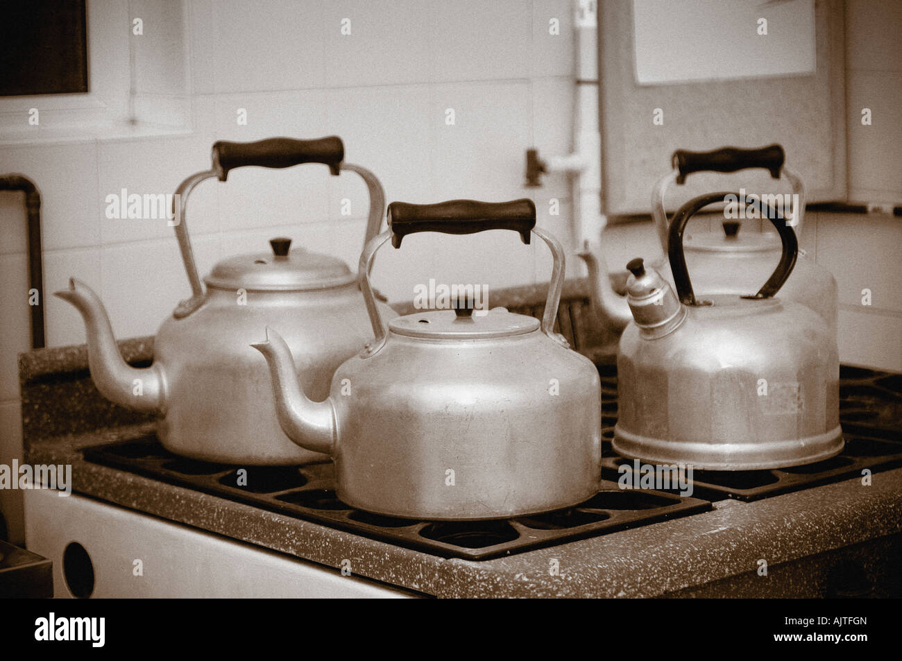 Large catering size aluminum kettles on a 6 burner gas hob Stock Photo ...