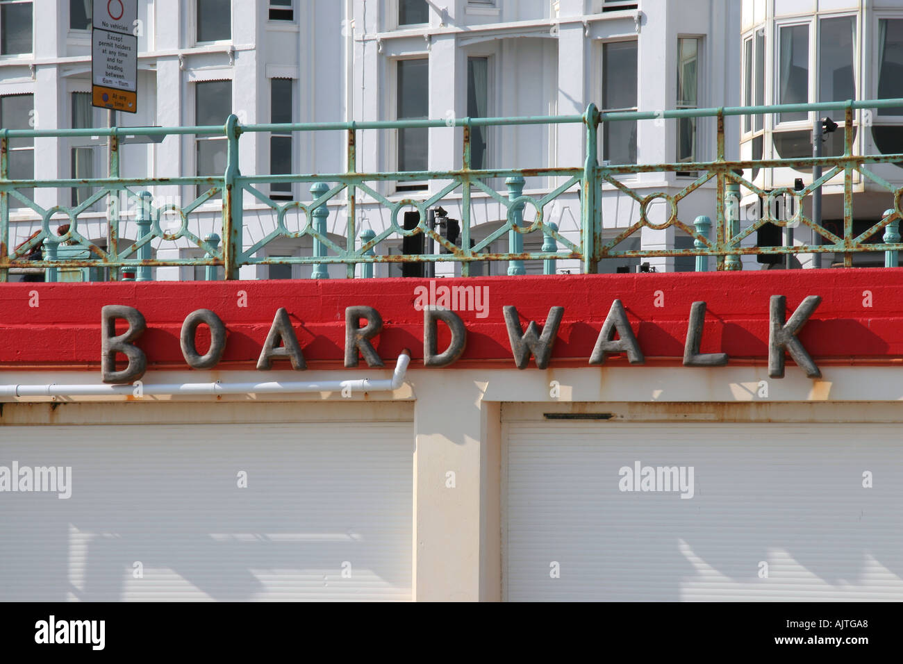 A sign saying boardwalk on the seafront at Brighton below the green ...